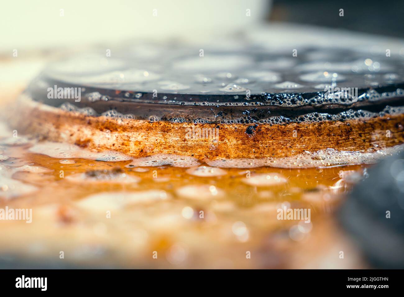 The surface of a very dirty kitchen electric stove in a bright ...