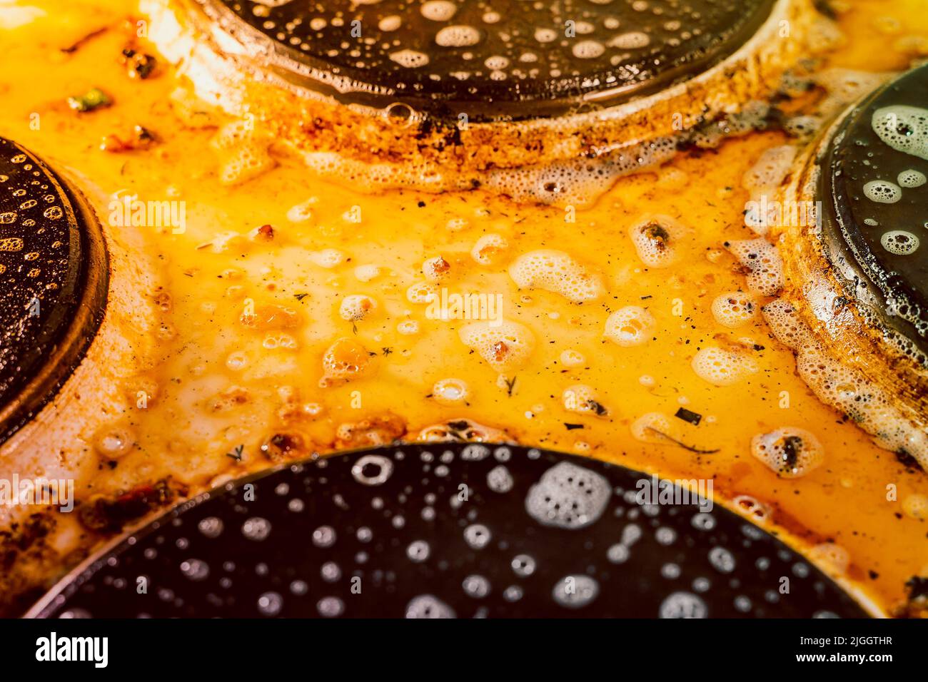 The surface of a very dirty kitchen electric stove in a bright ...