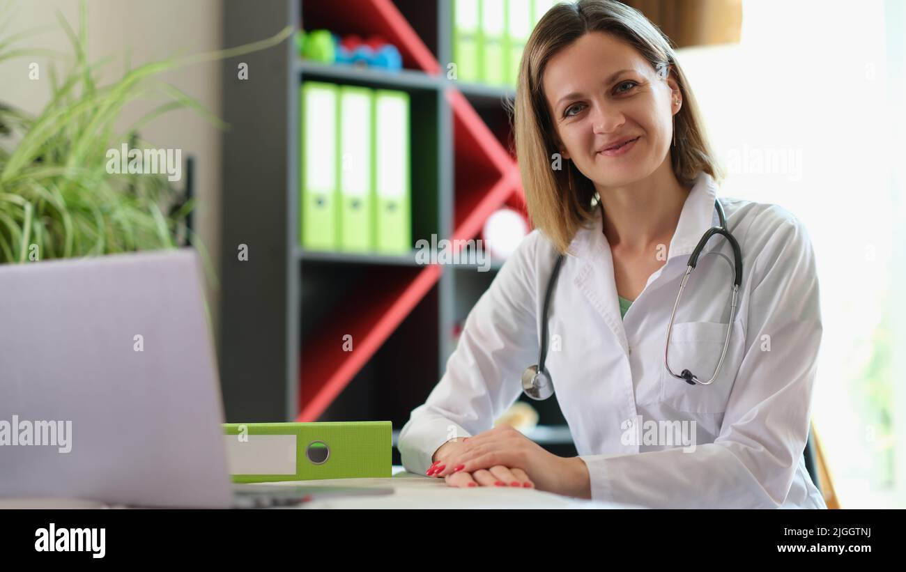 Happy smiling female practitioner posing in clinic office Stock Photo ...