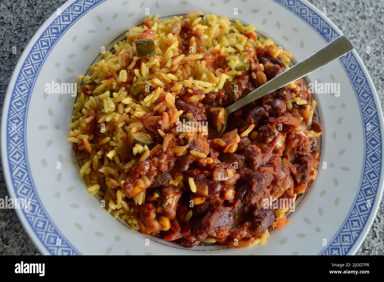 Chili beans and turmeric rice Stock Photo - Alamy