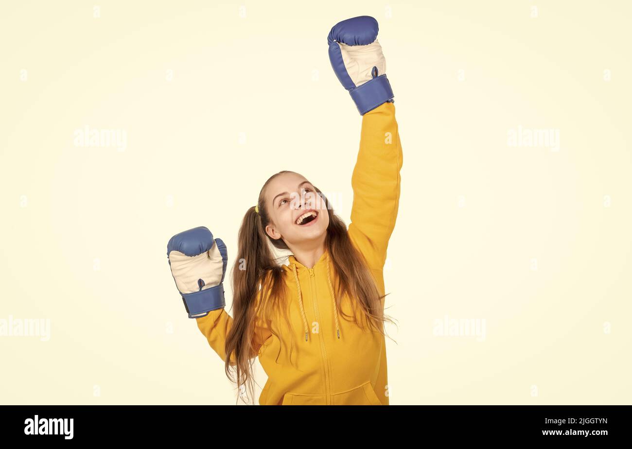 she is champion. winner of fight. teen girl in boxing gloves ...
