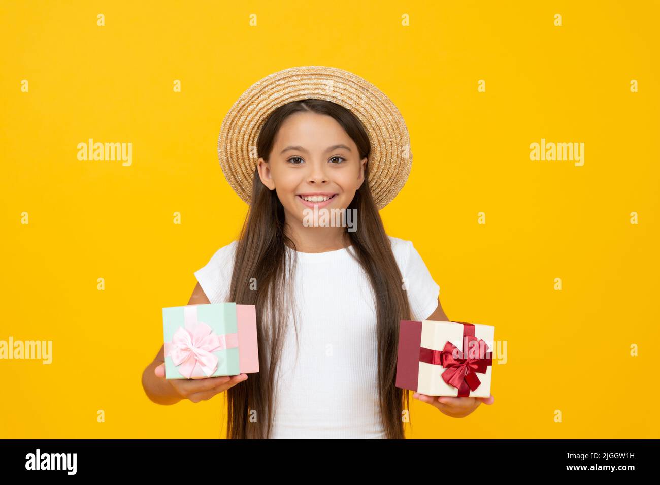 cheerful teen girl hold present box on yellow background Stock Photo ...
