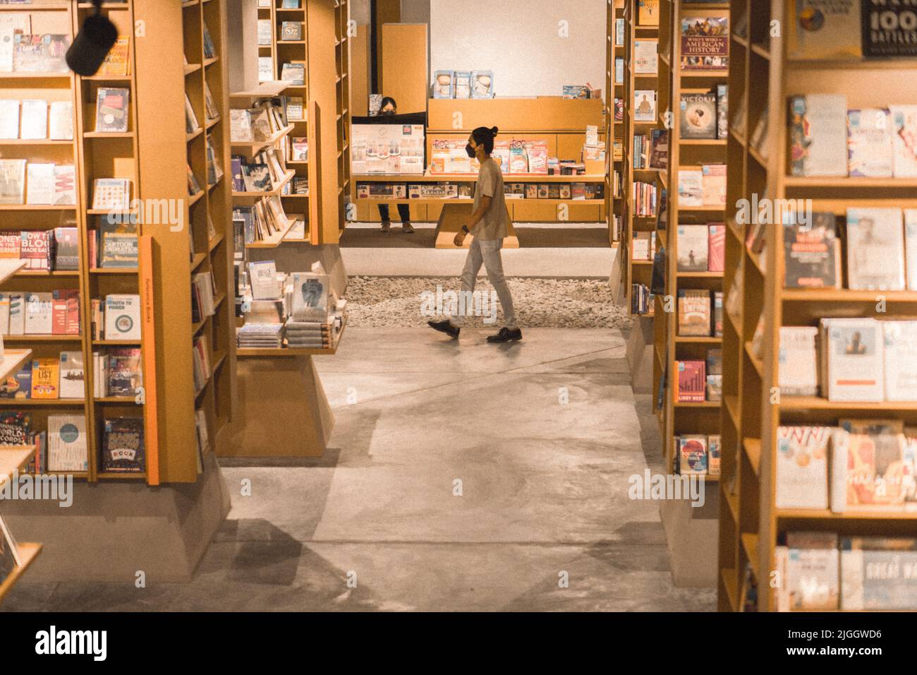 Man with books walking hi-res stock photography and images - Alamy