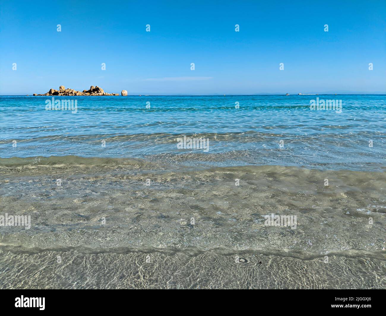 Beautiful beach with turquoise water and a rock in the background Stock ...