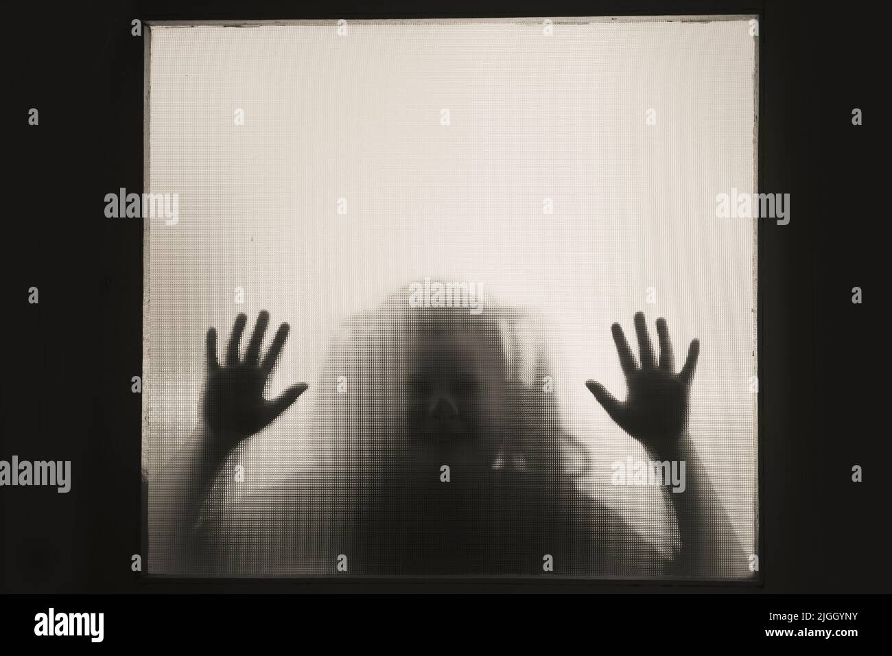 Horror ghost girl behind the matte glass in black and white. Halloween ...