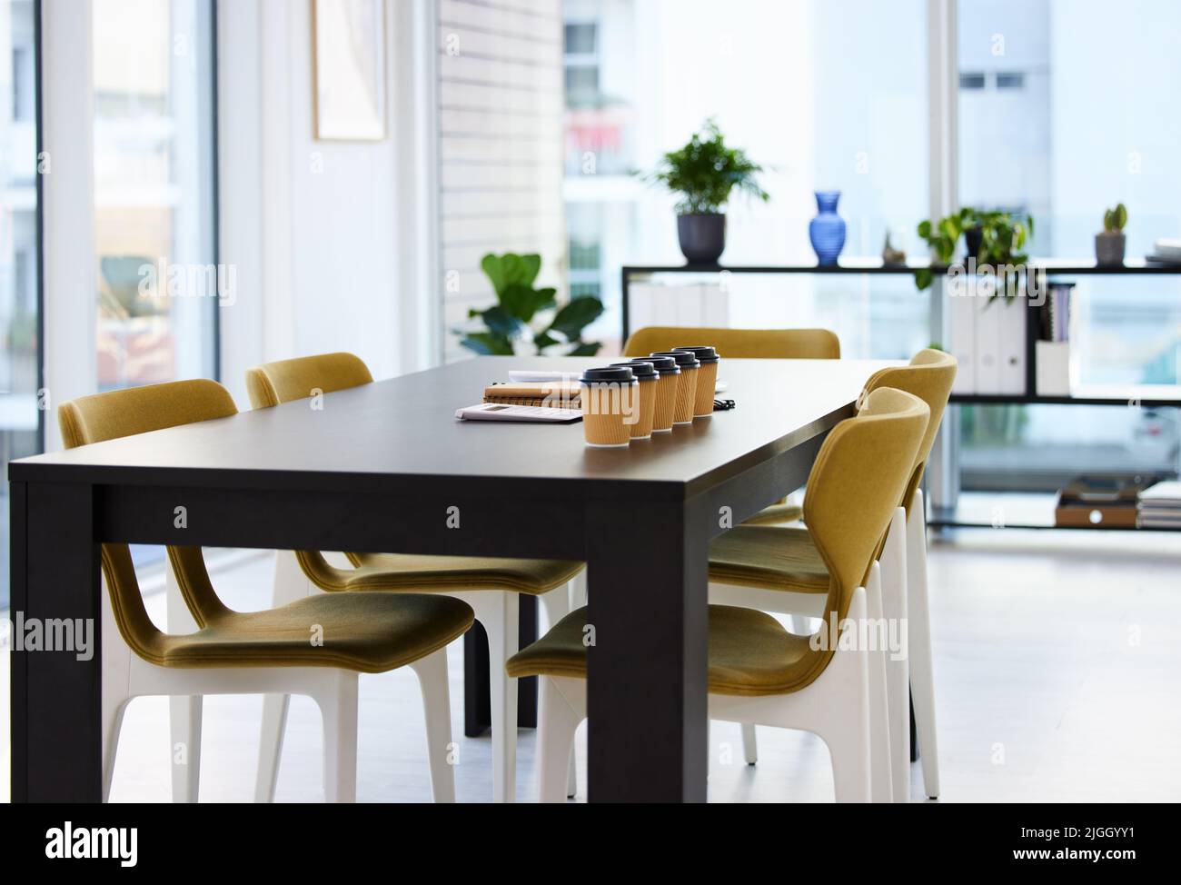 Lets get brainstorming. coffee and paperwork on a desk in an empty ...