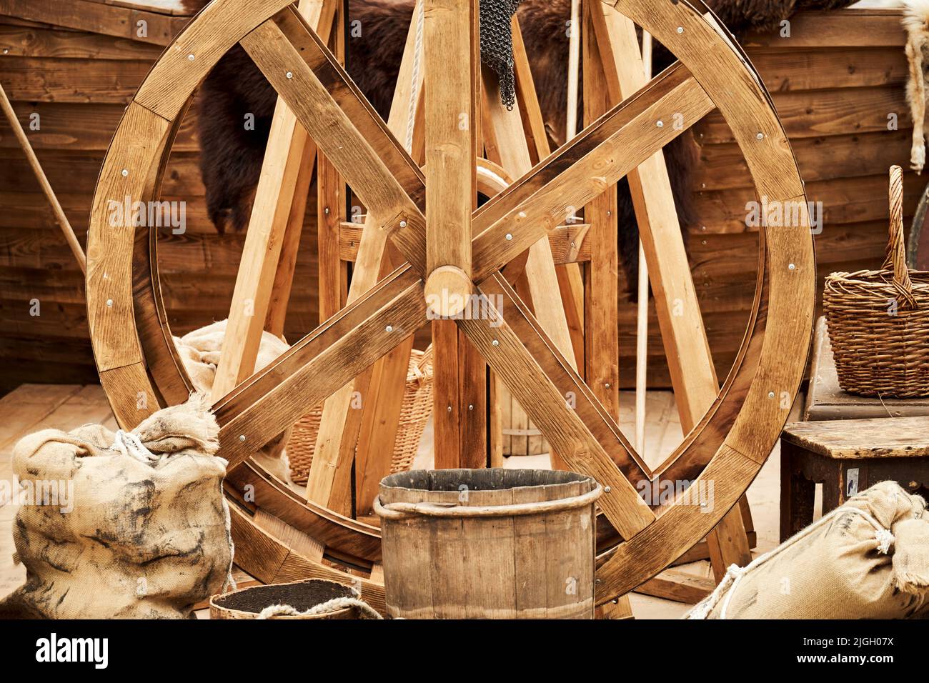 A medieval port with a wooden winch for lifting cargo onto ships ...