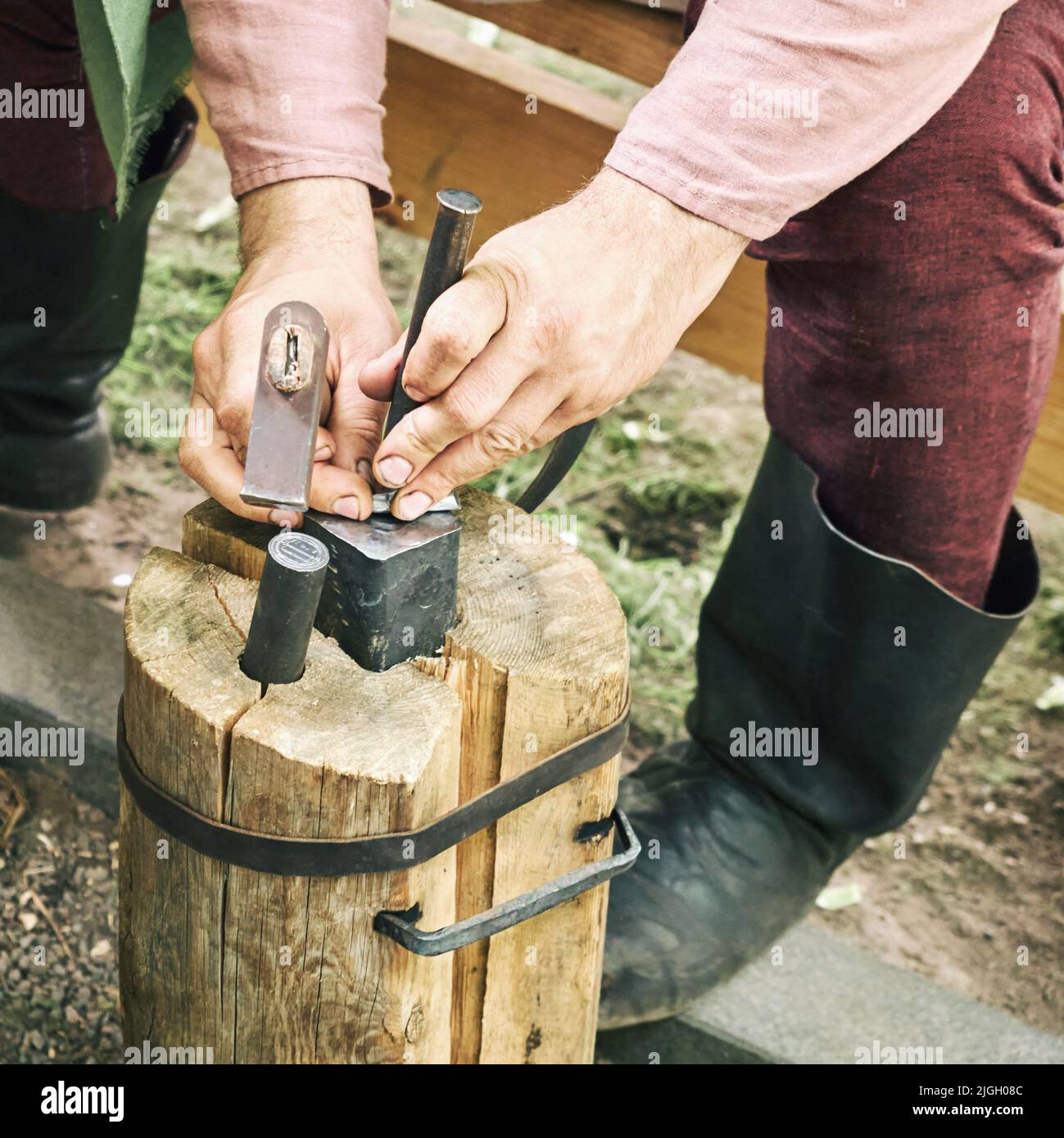 Production of medieval coins by casting and forging. Reconstruction of ...