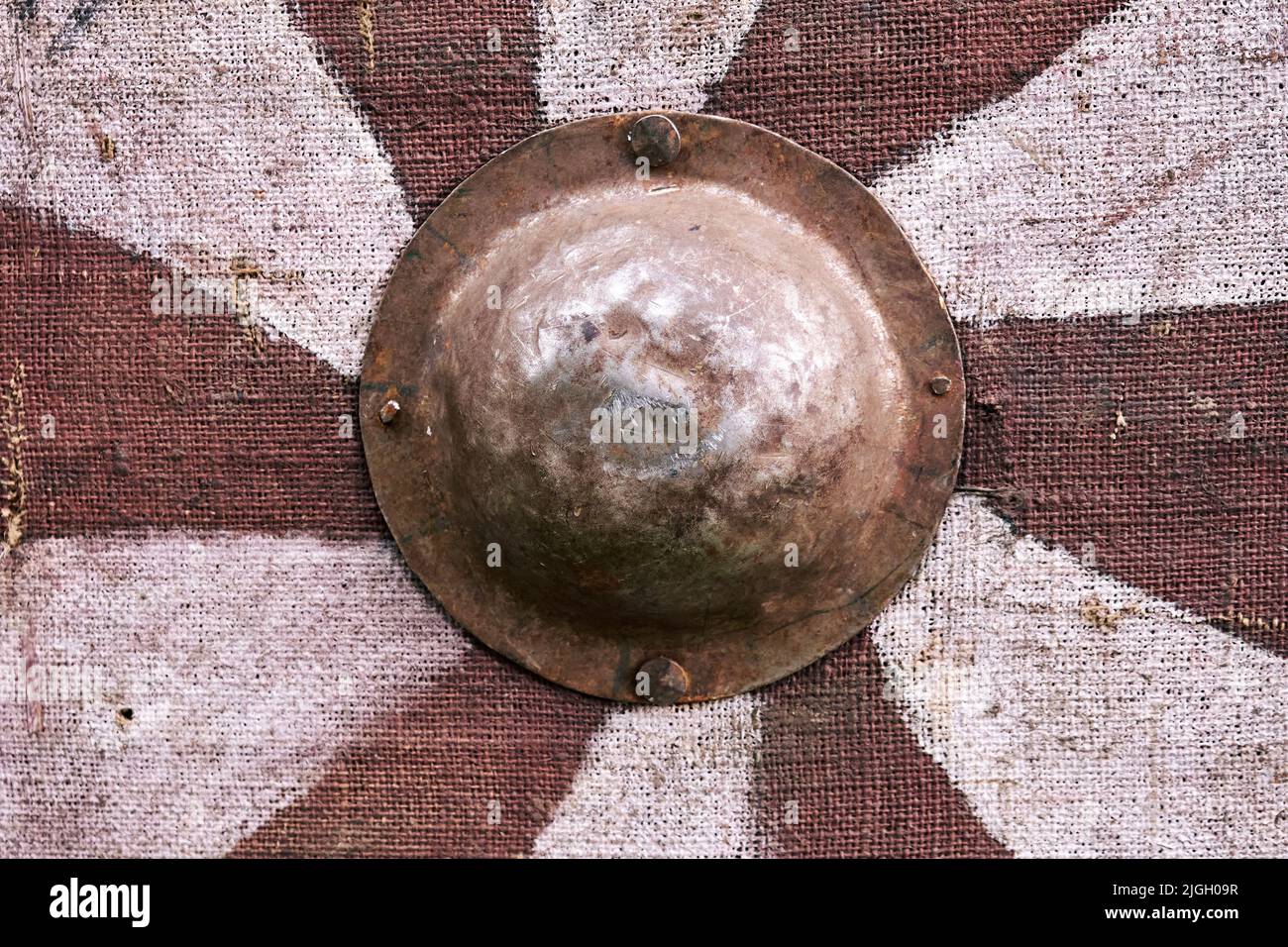 Red vintage shild with white spiral stripes a medieval warrior ...