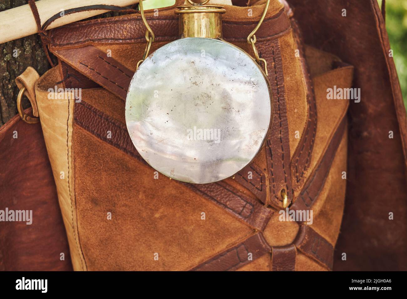 An ancient Roman flask and a vintage leather hiking bag. Reconstruction ...