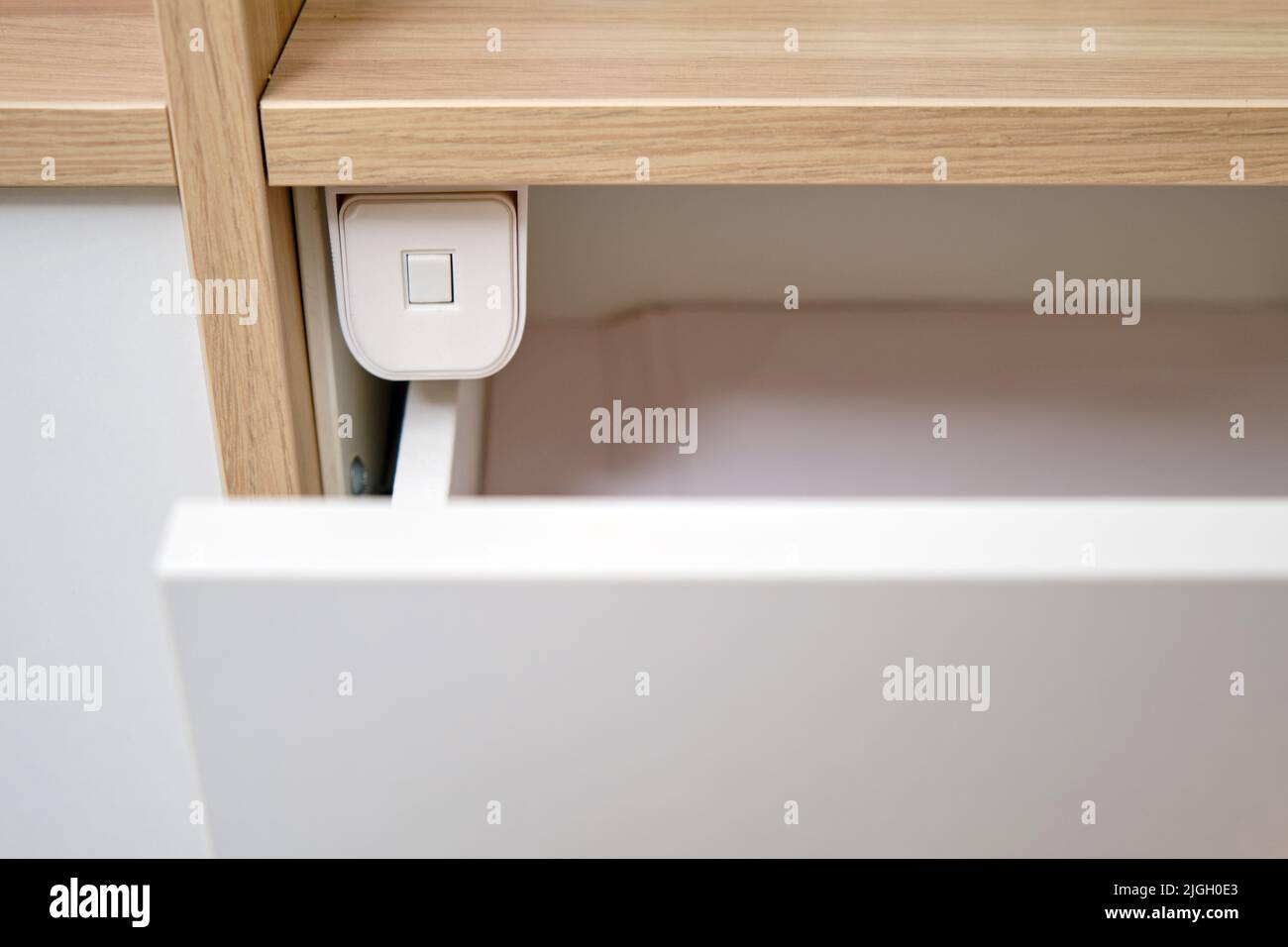 Magnetic child-proof lock for locking cabinet doors and drawers of home furniture Stock Photo ...