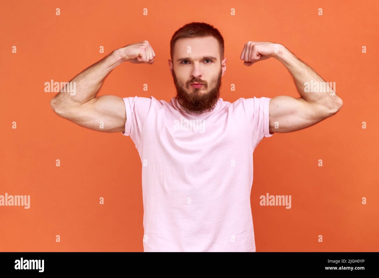 Portrait of strong bearded man demonstrating power in his hands ...