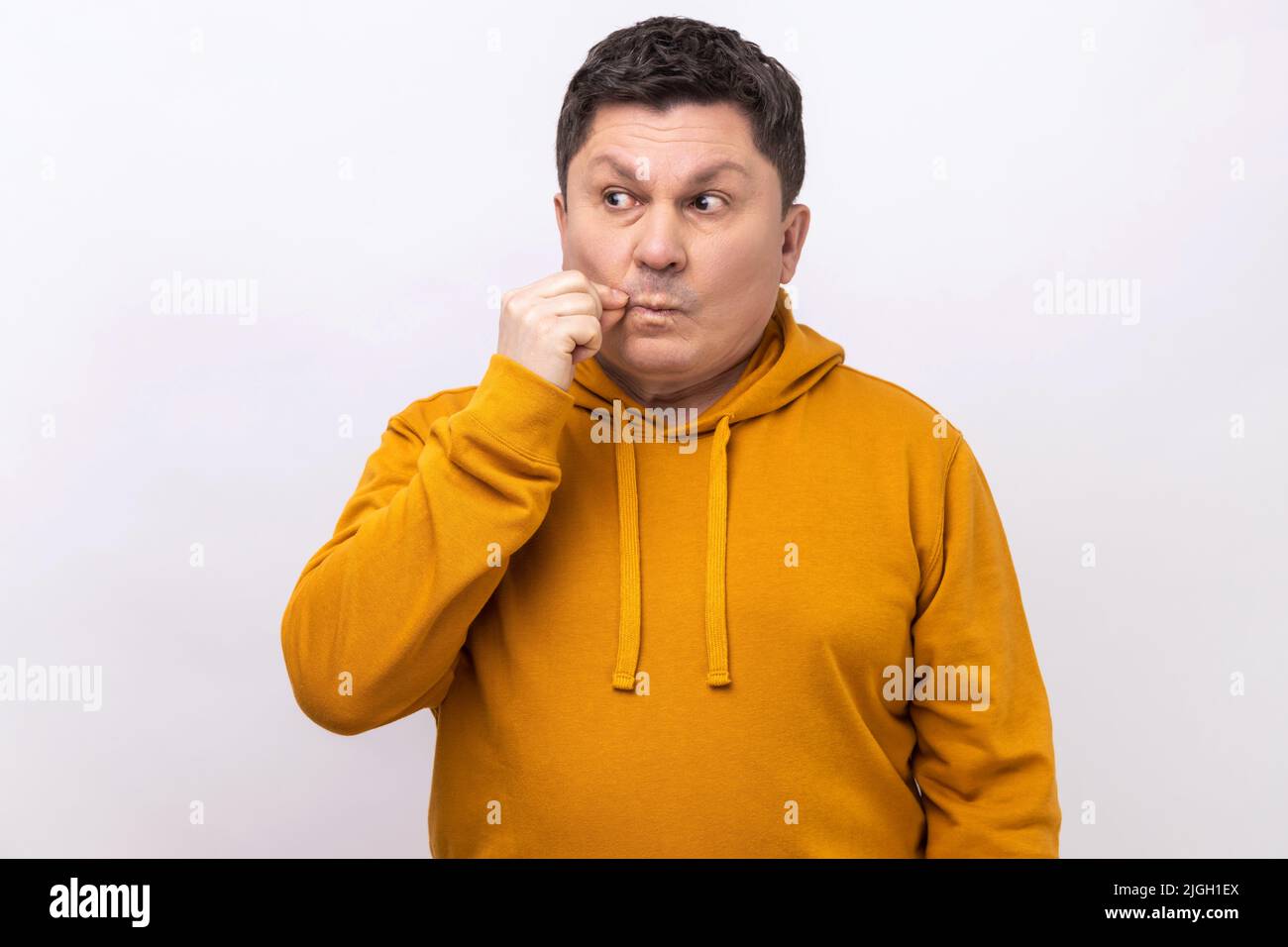 I won't tell anyone, promise. Middle aged man making zip gesture to ...