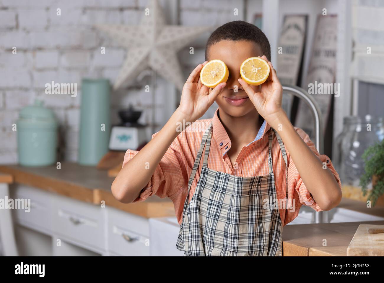 Black boy kid cooking fresh lemon on kitchen at home. African child ...