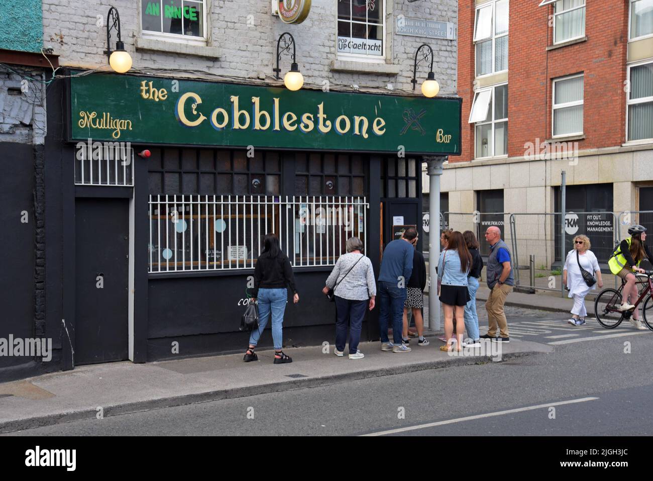 People drinking outside Cobblestone pub, a traditional Irish bar in ...