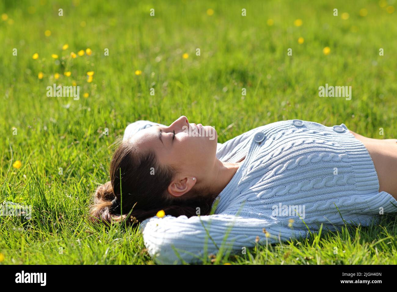 Woman resting and relaxing lying on the grass in the mountain Stock ...