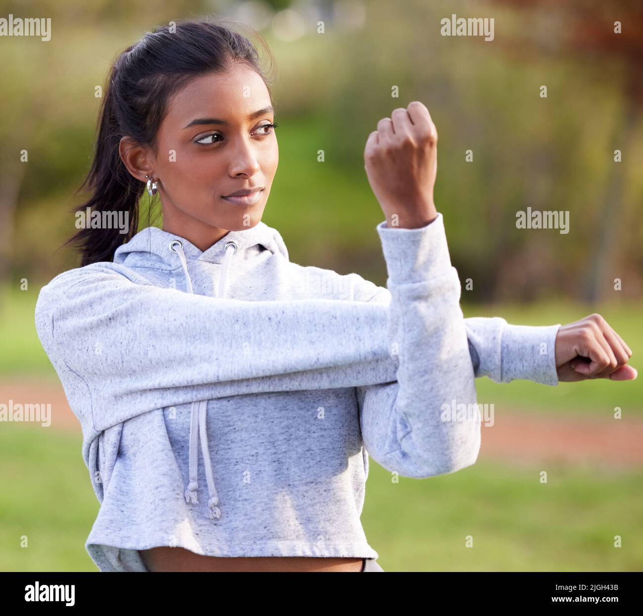 Get stretched, its go time. a young woman stretching during her workout ...