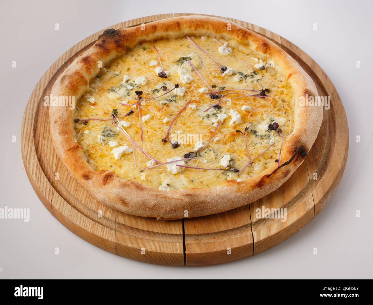 Top view of hot pizza on a wooden stand. Pizza Formaggio, 5 cheeses ...