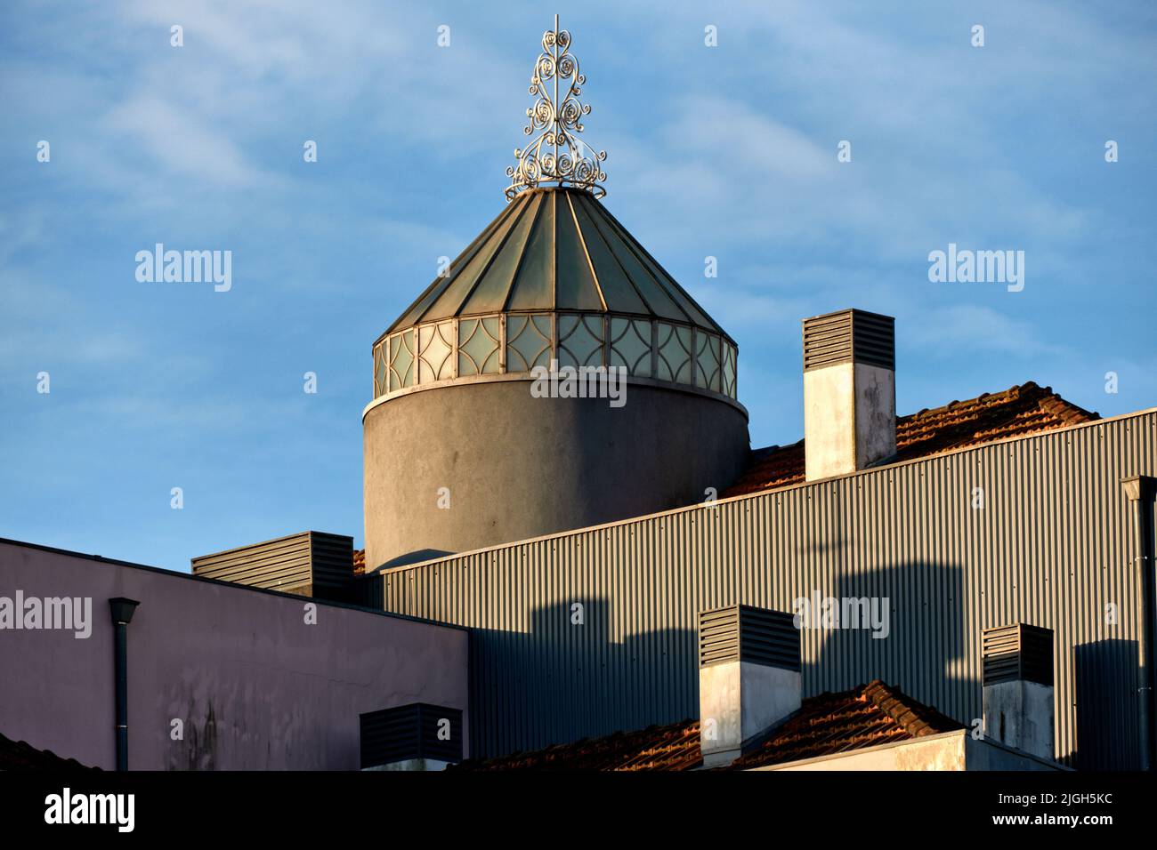 traditional glass skylights topped with a wrought iron spire on a roof ...