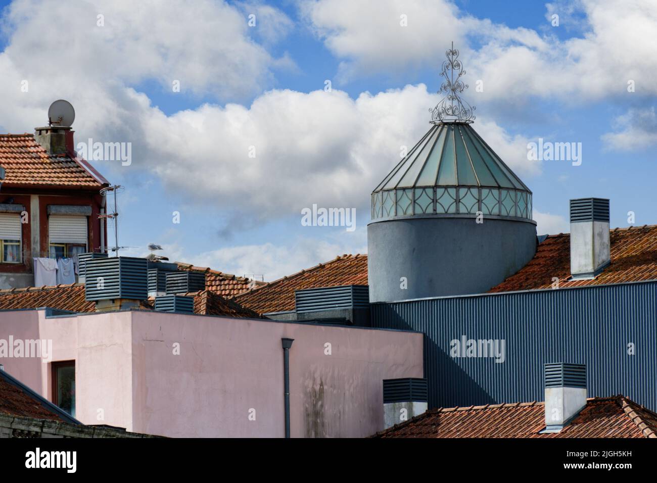 traditional glass skylights topped with a wrought iron spire on a roof ...