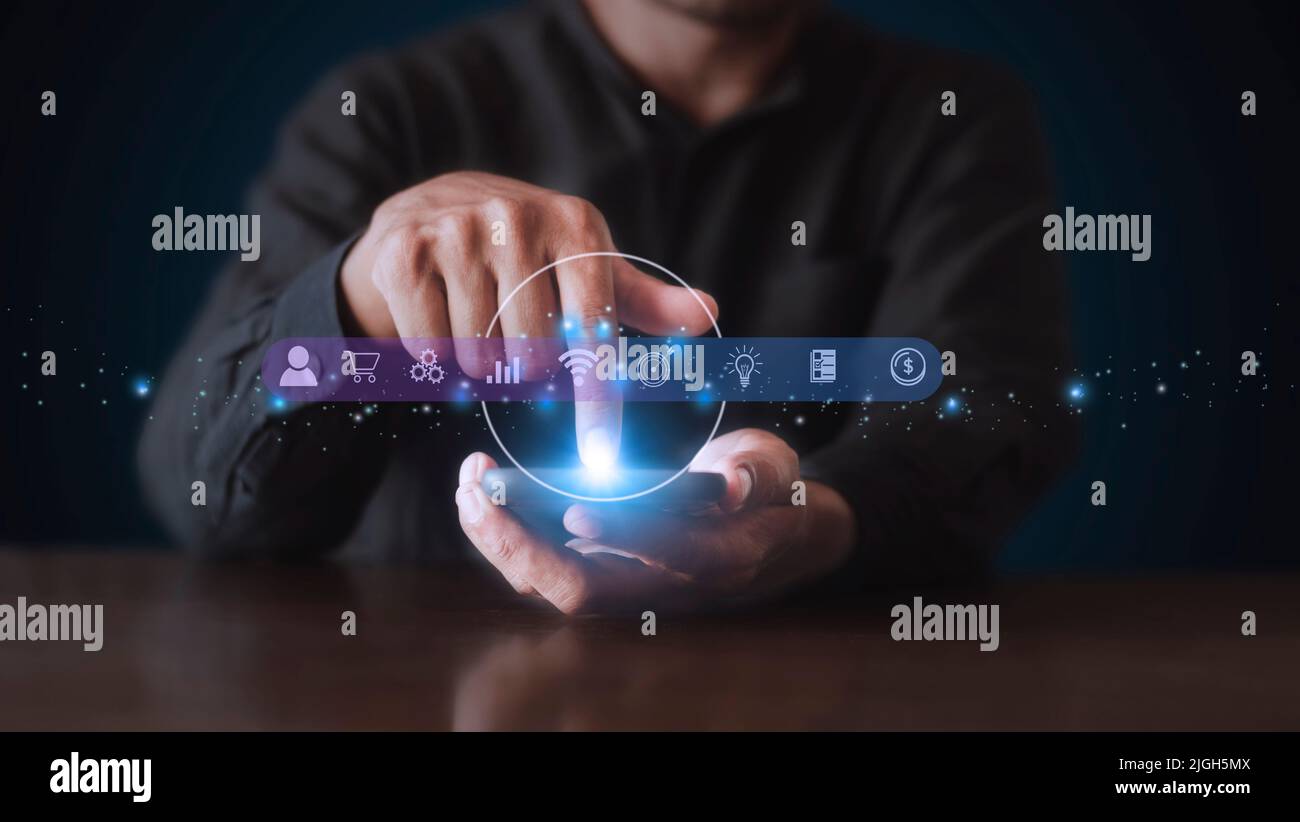 Businessman using phone and touching on virtual screen contact icons ...