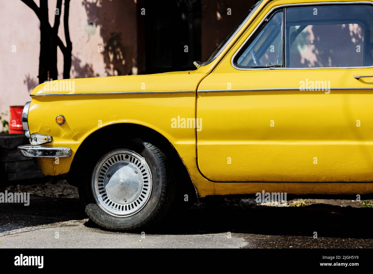 Yellow vintage car parked in a street. classic auto. antique vehicle ...