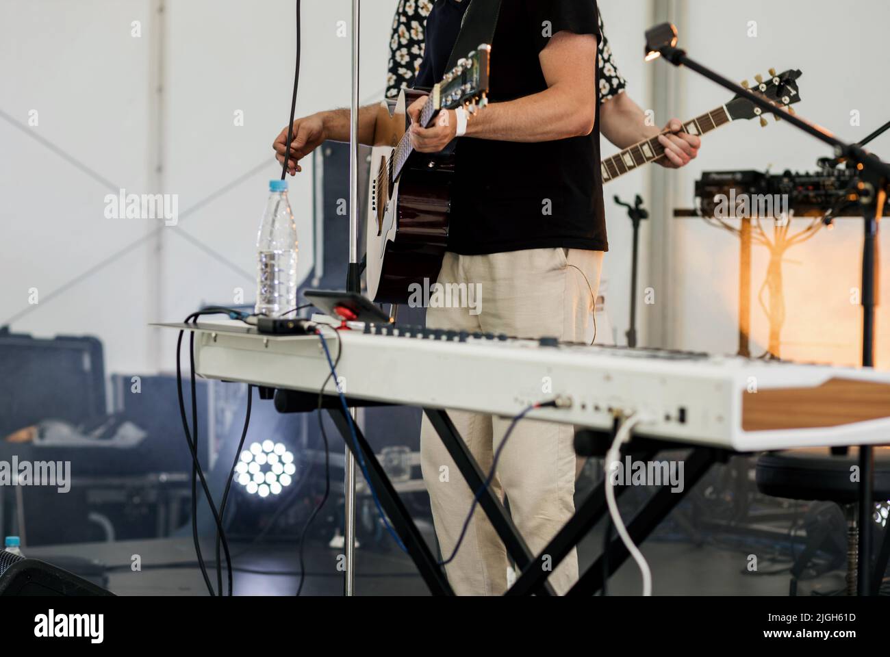 live performance of a musician with guitar and synthesizer on stage ...