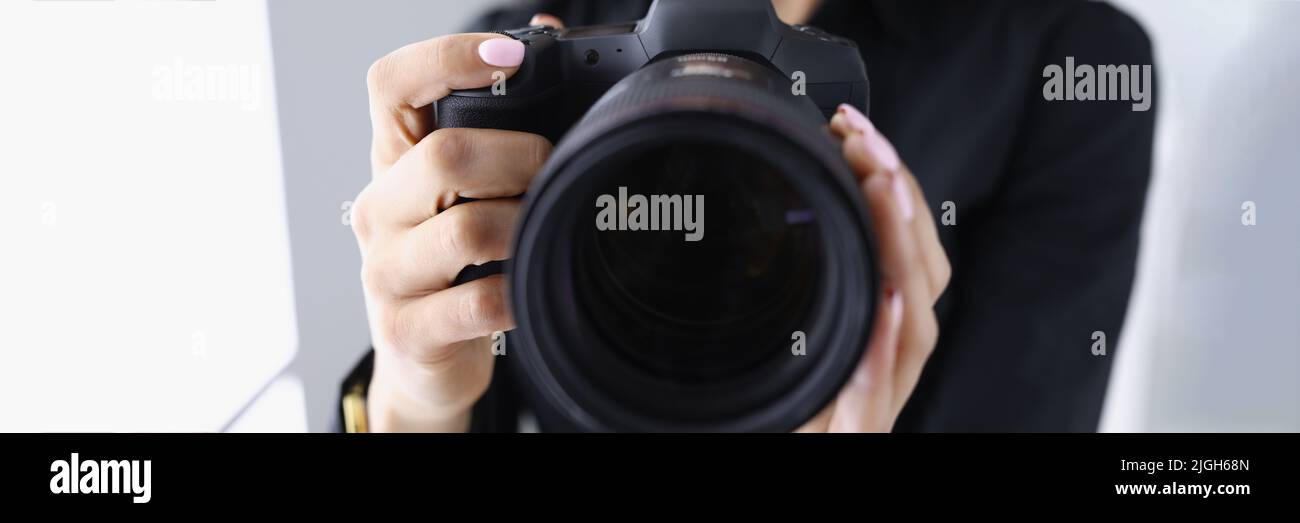 Professional woman photographer hold last model of photocamera Stock ...