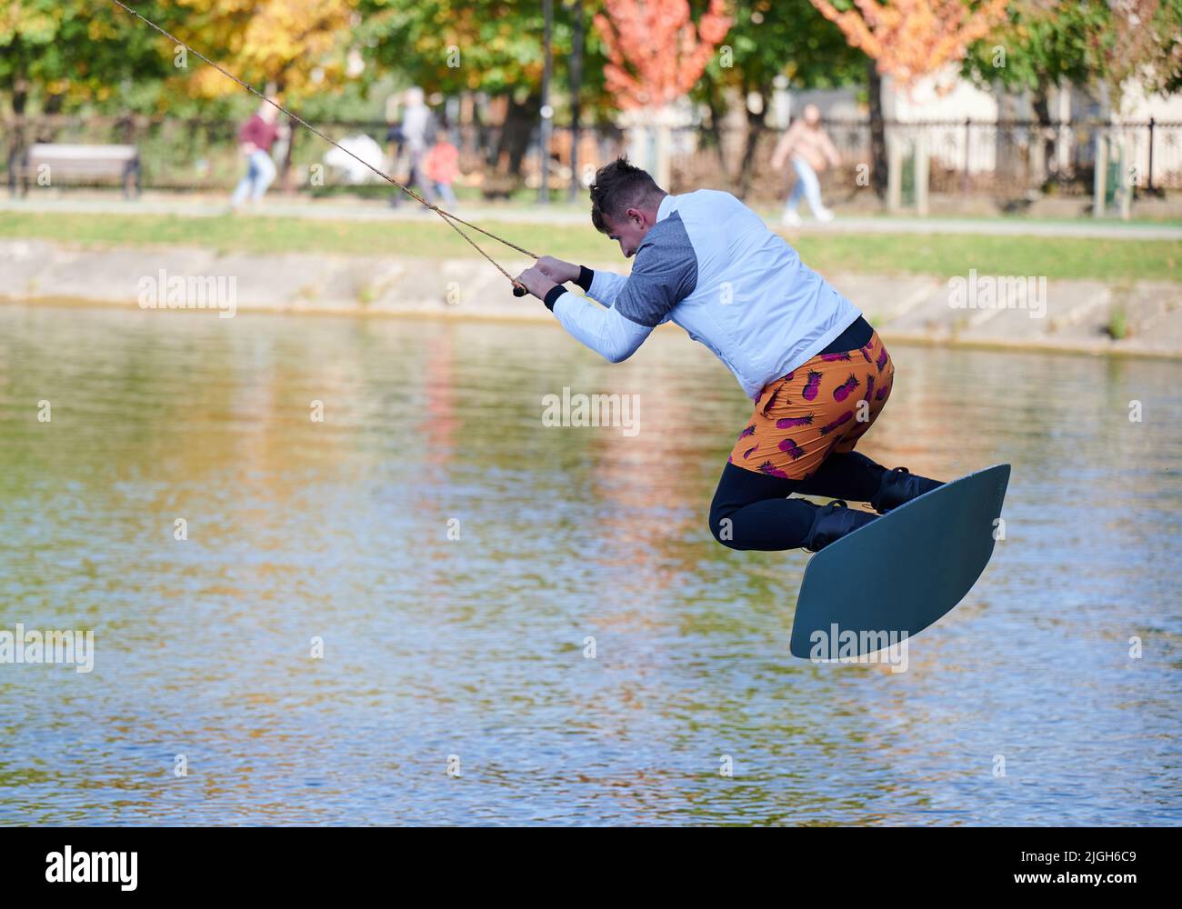 Wakeboarder surfing on lake. Young man surfer having fun wakeboarding ...