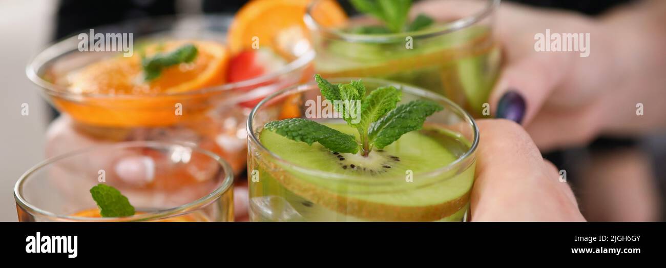 People holding cooling drinks cocktails and make clink with glasses ...