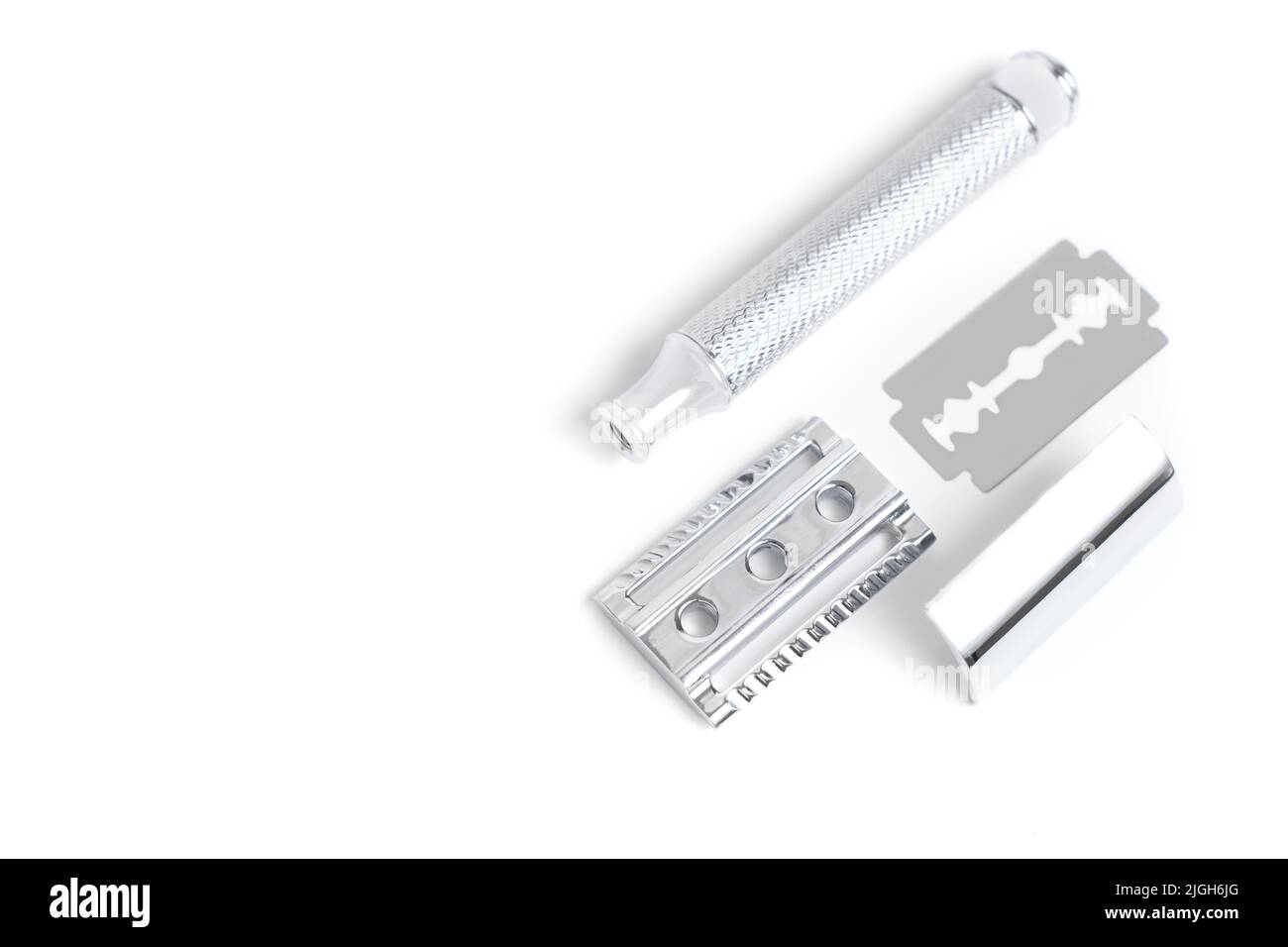 Traditional chrome-plated closed-comb safety razor disassembled on ...