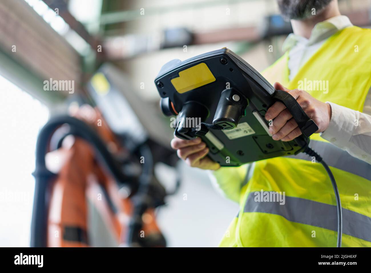 Close-up of automation engineer holding scanner in industrial in ...