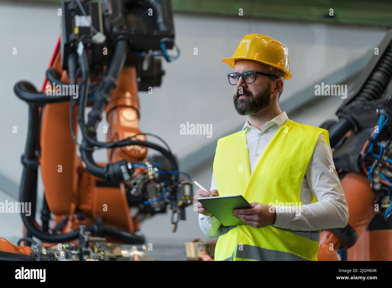 Automation engineer holding scanner in industrial in factory Stock ...