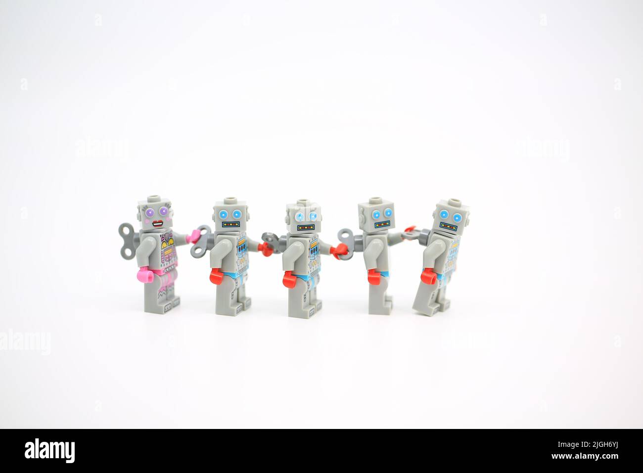 a list of clockwork robots help each other to wind up their clockwork ...