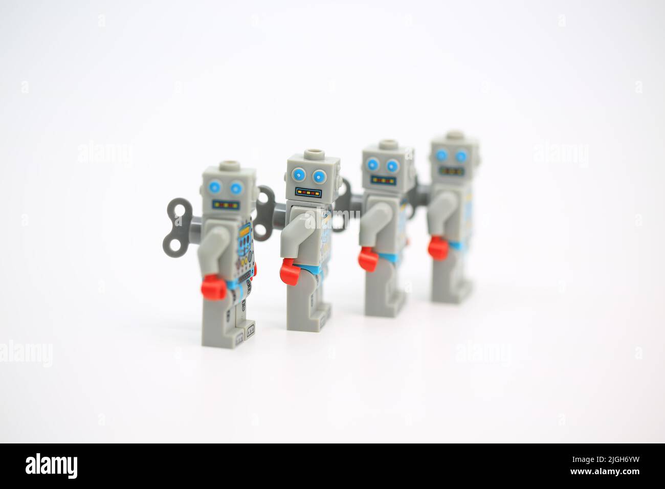 a list of clockwork robots help each other to wind up their clockwork ...