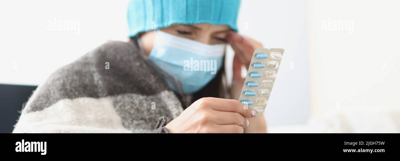 Woman hold blister with tablets in hand, feeling unwell, bad headache ...