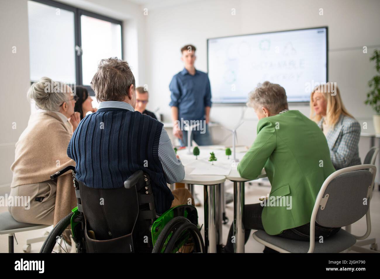 Group of senior students discussing about altenrative energy with ...