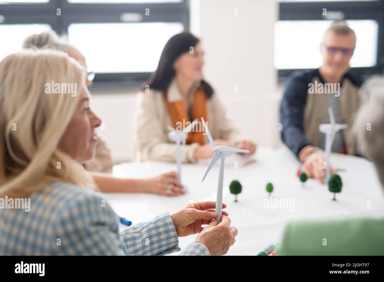 Group of senior students discussing about altenrative energy in ...