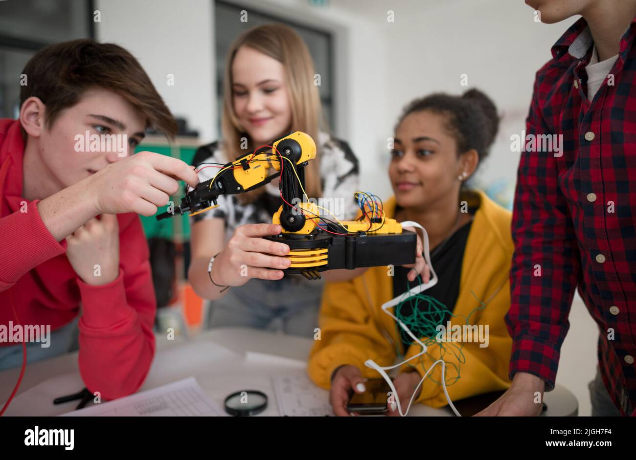 Group of students building and programming electric toys and robots at ...