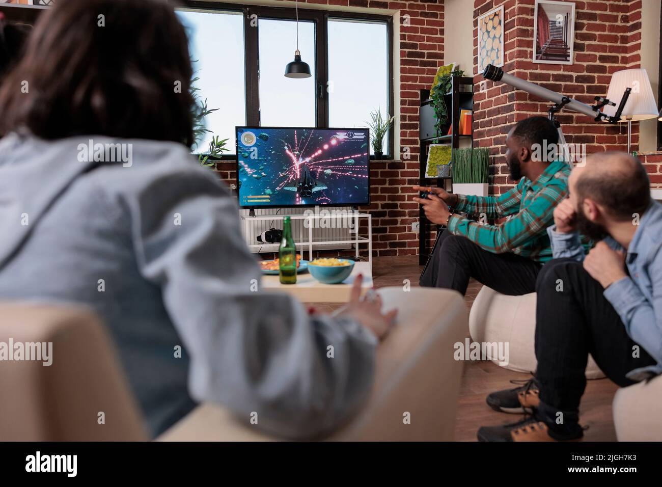 African american man playing video games on tv console, using strategy ...