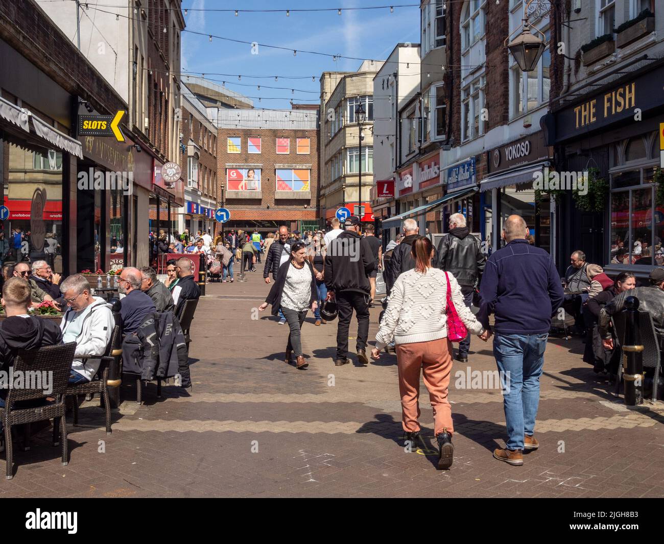 Pavement cafes and visitors on a summer day in a pedestrianised area of ...