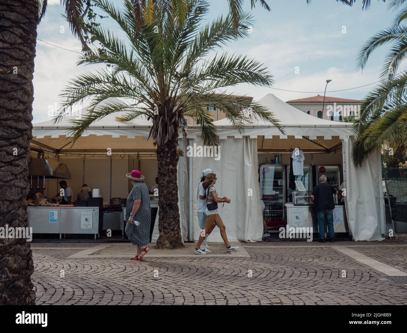 People walking near the sea and boats Stock Photo - Alamy