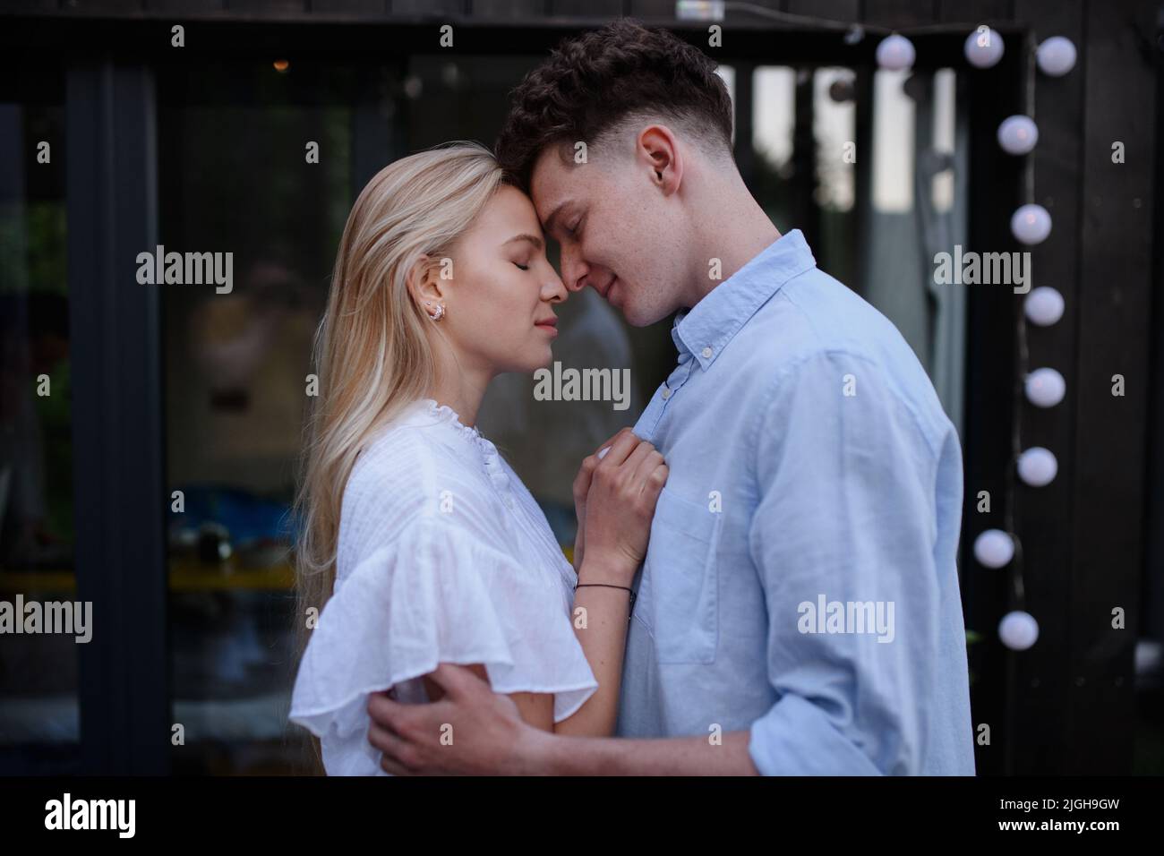 Young couple in love cuddling and kissing outdoors on terrace, weekend ...