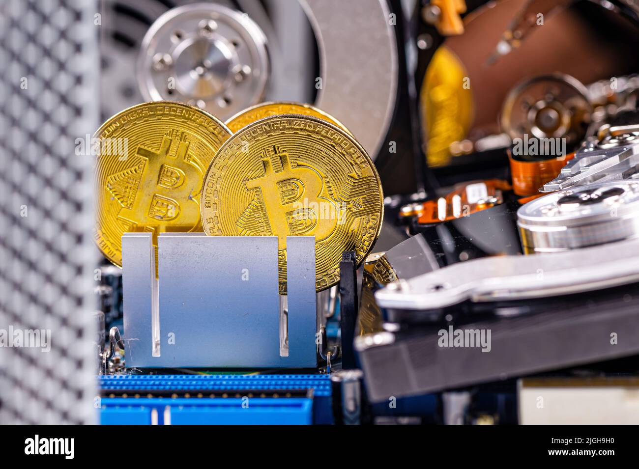 close-up of gold bitcoin on computer components background, technology ...