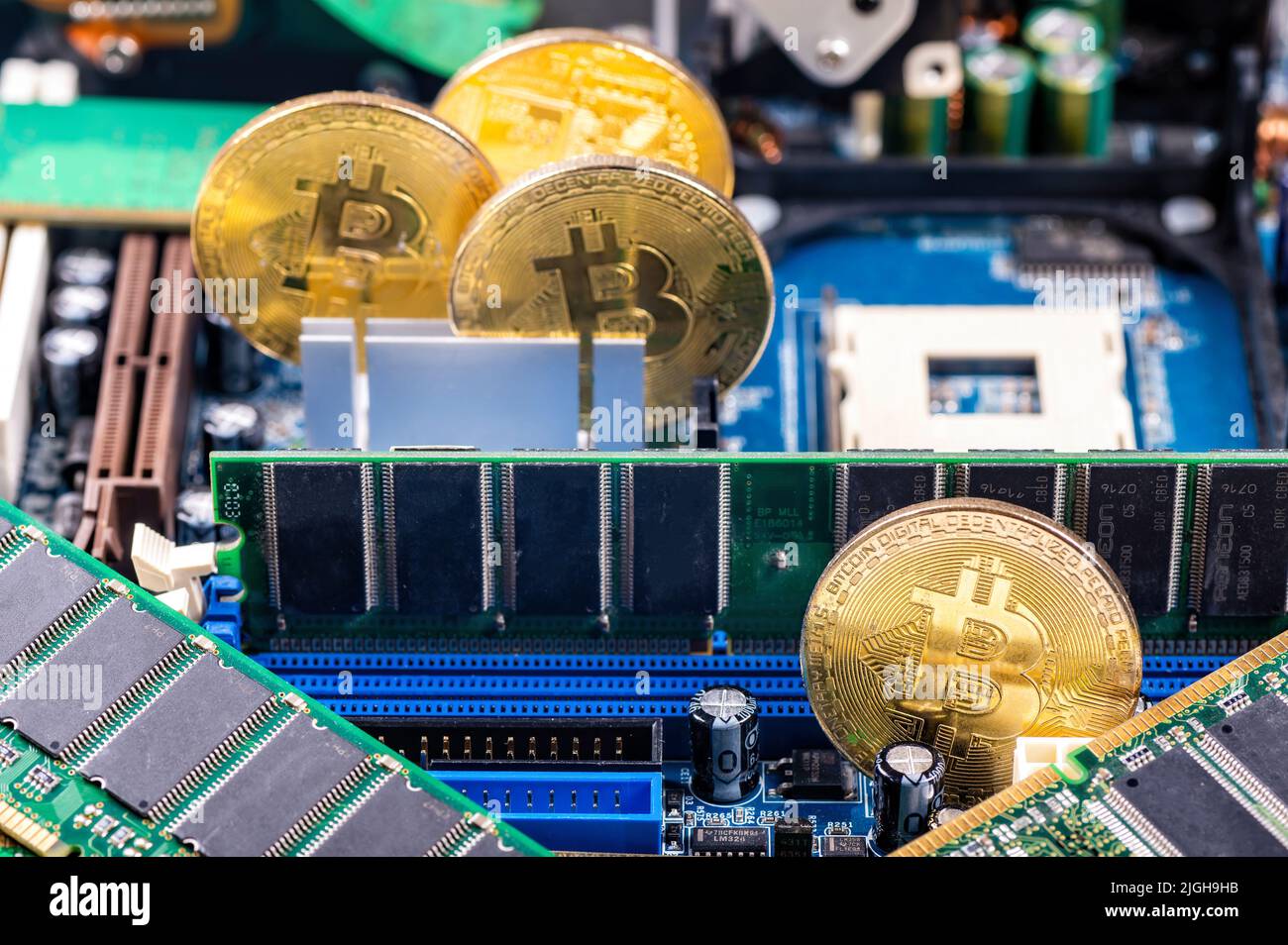 close-up of gold bitcoin on computer components background, technology ...