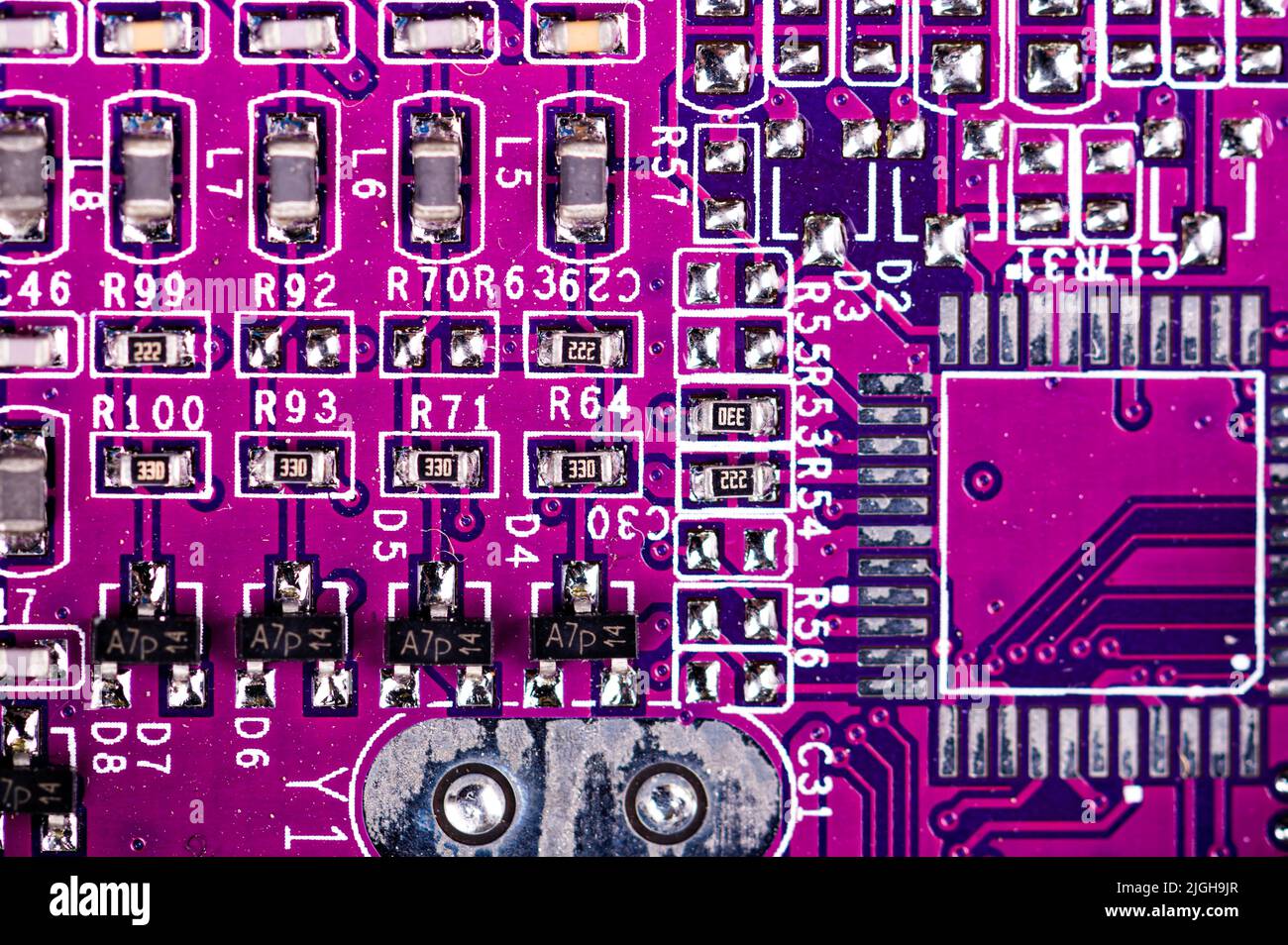 macro close-up shot of microchip on red printed circuit board, computer motherboard with ...