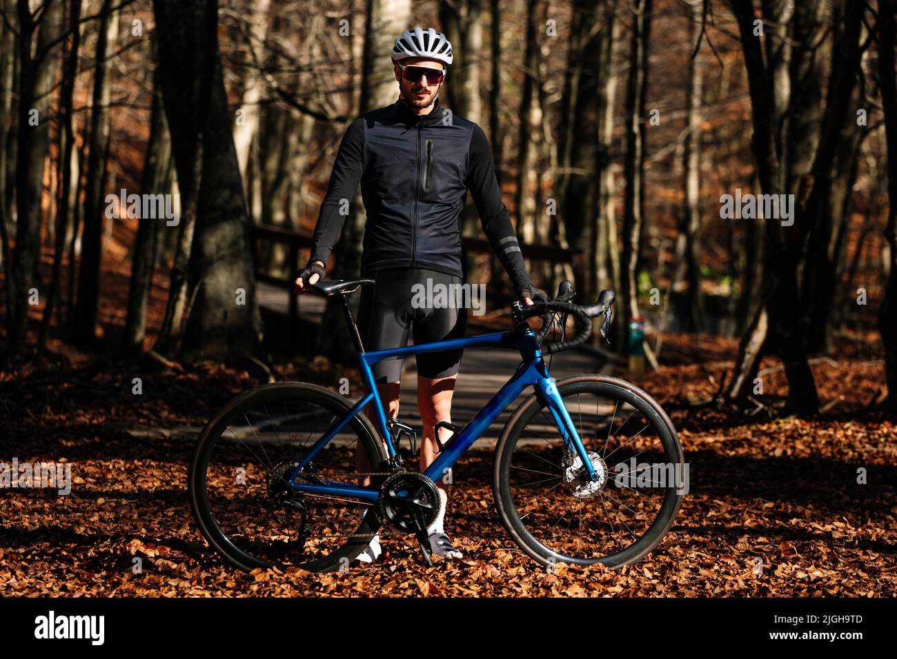 A professional male cyclist with sunglasses in an autumn forest Stock ...