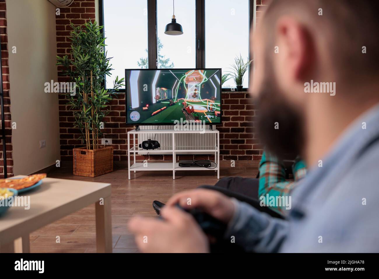 Group of young people having fun with video games competition on ...