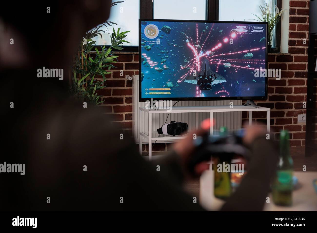 African american woman playing video games with television console ...