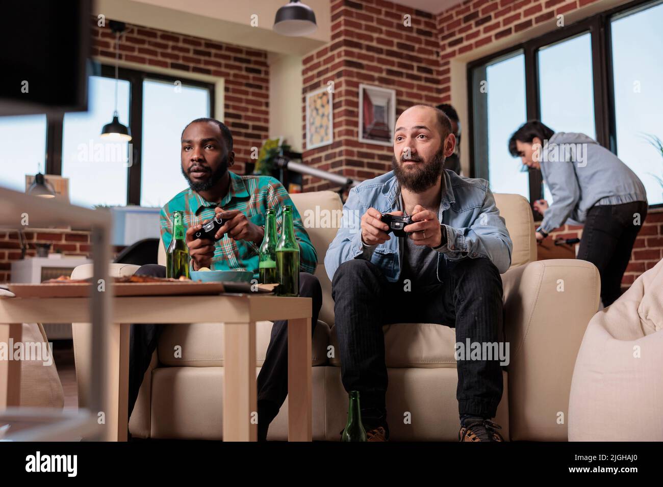Happy people doing teamwork and playing strategy video games on tv ...